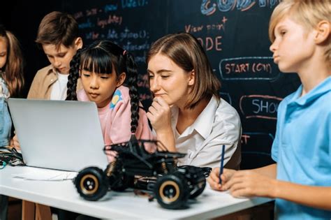 Premium Photo Schoolgirl Pink Cloth Use Laptop For Coding While Teacher Watch Her Erudition