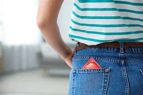 Woman With Condom In Pocket Of Her Jeans Indoors Safe Sex Concept Stock Image Image Of