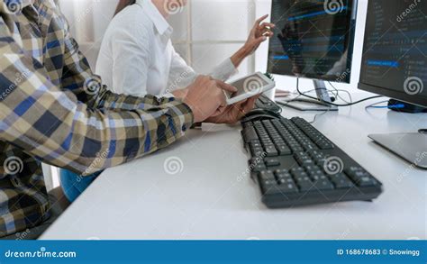 pensive programmer working on desktop pc programming code technologies