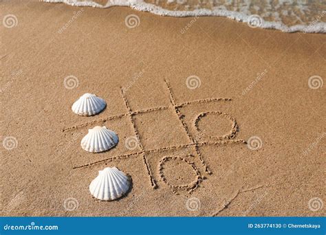 Playing Tic Tac Toe Game With Shells On Sand Near Sea Above View Stock