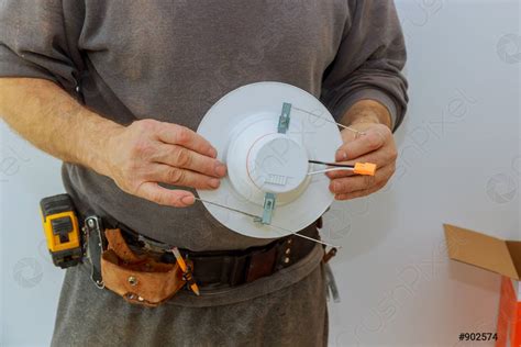 Man Is Installing Electrical Light In The Ceiling Replacing Repair Stock Photo Crushpixel