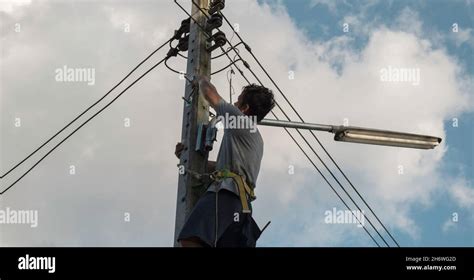 Electrician Repairman Are Climbing And Work On Electric Pole Concept