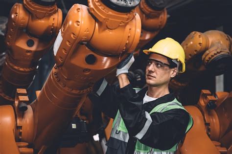 Premium Photo Engineer Team Service Fix Robot Welding Arm Working In