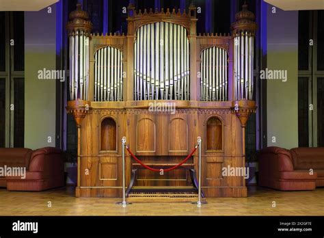 massive wooden pipe organ with many metal pipes and ornate finishing