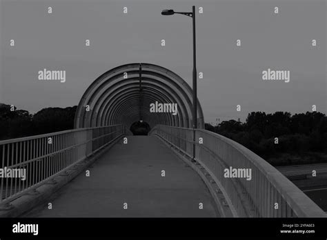 Pedestrian Overpass With A Curved Metal Tunnel Safety Barrier Railings