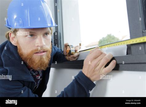 Service Man Measuring Window For Installation Indoors Stock Photo Alamy
