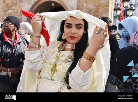 A Tunisian Woman Dressed In Traditional Clothes Takes Part In A March