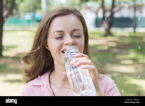 Young Woman Drinking Mineral Water From Plastic Bottle Hi Res Stock