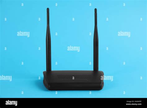 Modern Wi Fi Router On Light Blue Background Stock Photo Alamy
