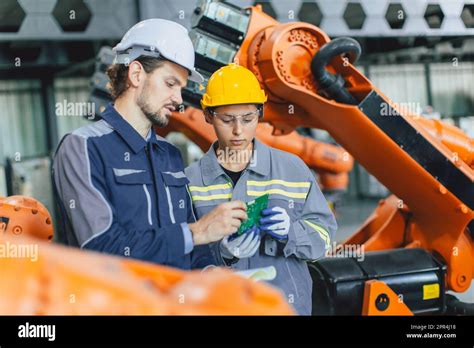 Engineer Team Working Together Inspection Quality Robot Arm In Robot