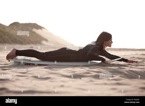 Female Surfer Practising On Dry Land Before Entering Water Stock Photo Alamy