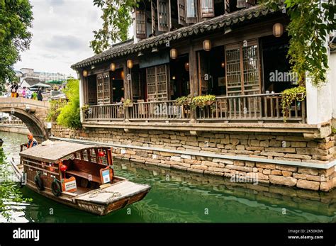 A Tourist Boat Passing A Teahouse On Pingjiang River Alongside Pingjiang Lu A Street Full Of Old