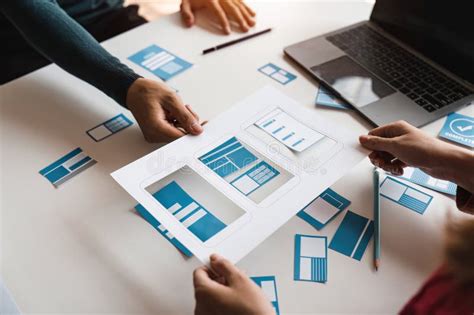 Close Up Ux Developer And Ui Designer Brainstorming About Mobile App