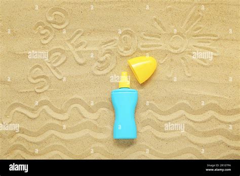 Creative Composition With Sunscreen Cream And Drawings On Sand Stock