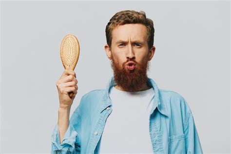 Premium Photo Portrait Of A Man With A Massage Comb In His Hands