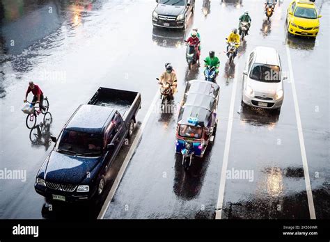 Cars Vans Buses And Motorbikes All Pass Along A Busy Intersection On