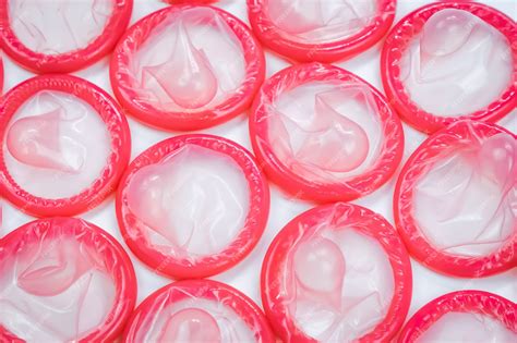 Premium Photo Top View Of Pink Condoms On White Background