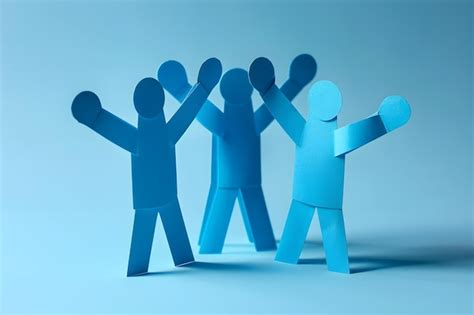 Blue Paper Cutout Figures Celebrating On Light Blue Background Teamwork Togetherness Unity