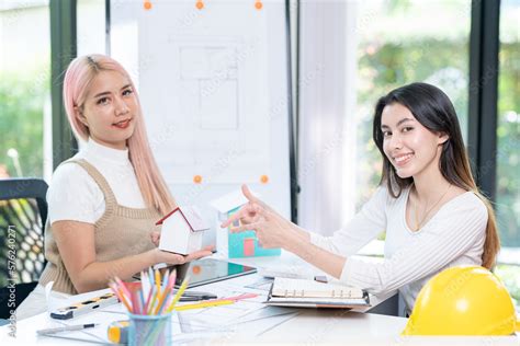 Concept Of Engineering Consulting Two Female Engineers Discussing About Model Of Building