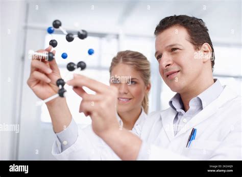 Molecular Structures Are Fascinating Two Scientists Looking At A Molecular Structure Model