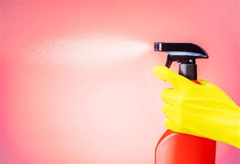 Premium Photo Cleaning With Spray Detergent Female Hand In Yellow