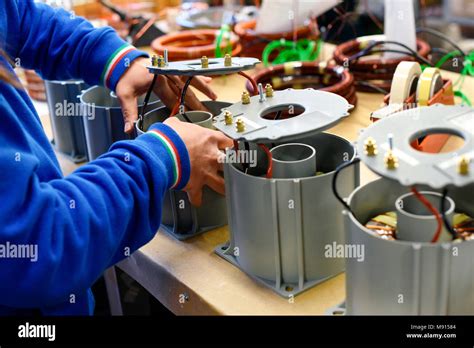 Worker Working On New Electrical Transformers In Workshop Stock Photo Alamy