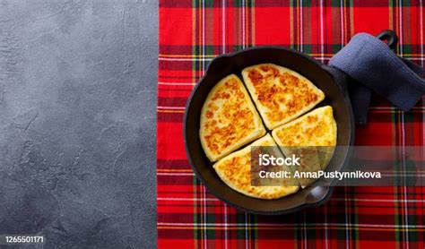 전통적인 스코틀랜드 타티 감자 스콘 주철 팬 격자 무늬 패브릭 냅킨 배경 공간을 복사합니다 맨 위 보기입니다 감자 요리에 대한