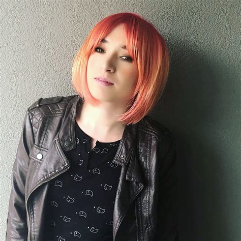 Modern Razor Cut Bob With Curtain Bangs And Neon Coral Pink Hand