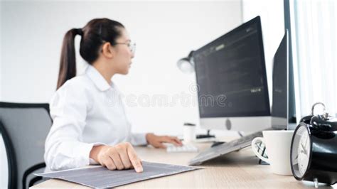 Young Asian Woman Programmer Typing Code Working With Computer At Table
