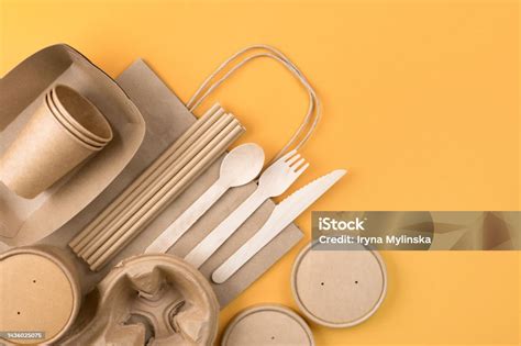 길거리 음식 종이 포장 재활용 가능한 기구 폐기물 제로 포장 복사 공간이 있는 주황색 배경 위에 친환경 식기 번들 지속 가능한 종이 식품 포장 플랫 레이 일회용품에 대한
