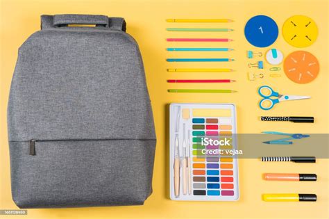 교육 학습 학교 배경으로 돌아갑니다 노란색 배경에 회색 배낭과 다양한 학교 문구류가 있는 놀링 구성 평면도 평지 0명에 대한