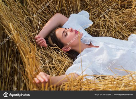 Sensual Woman Lying In The Hay Girl In White Shirt And Lies On A