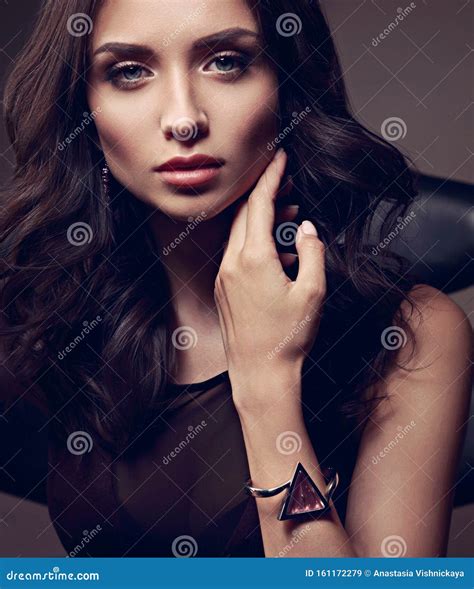 Young Makeup Model With Vamp Look Posing On Dark Shadow Background In Fashion Trendy Watch On