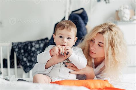Mother Playing With Her Baby In The Bedroom Stock Photo At Vecteezy