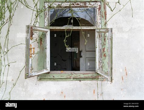 An Old And Rusty Open Window With Broken Glass In Middle Of A Chernobyl