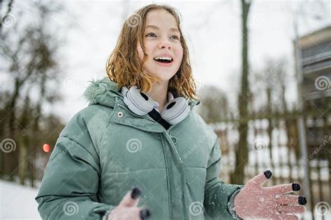 Cute Teen Girl Having Fun On A Walk In City Park On Chilly Winter Day