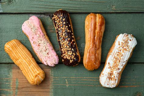 Assorted Eclairs On A Pastel Top View Traditional French Dessert Stock