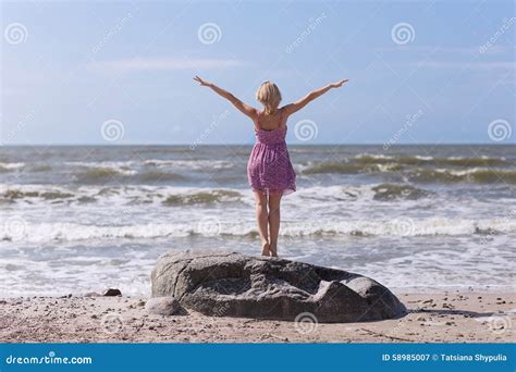 Young Beautiful Slim Girl Standing On The Beach On A Sunny Summer Day