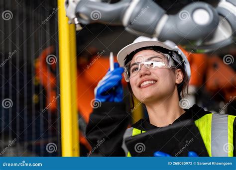 A Team Of Male And Female Engineers Meeting To Inspect Computer Controlled Steel Welding Robots