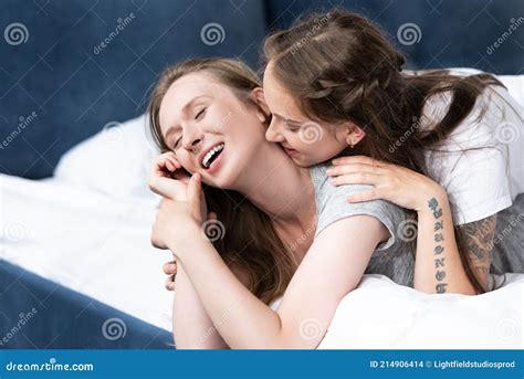 Two Lesbians Embracing With Closed Eyes While Lying On Bed In Morning Stock Photo Image Of