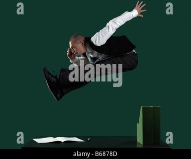 Young Businessman Over A Desk Full Of Thoughts Isolated In White