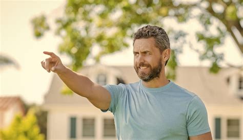 Premium Photo Happy Bearded Man Looking Forward And Pointing Finger