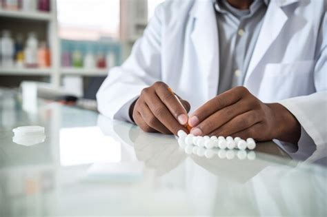 Premium Photo Photo Of A Pharmacist Counting Out Medication Tablets