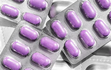 Several Of Blisters With Colored Purple Tablets Of Different Shapes
