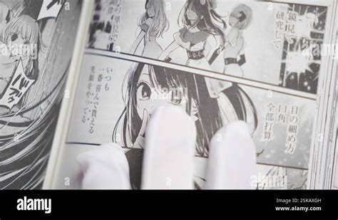 Person Hand In White Gloves Slide Over A Page In Japanese Manga Comic