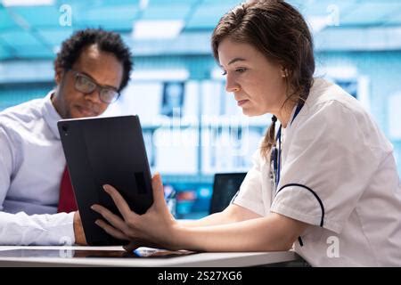 Healthcare Provider Presenting Lab Test Results To A Patient In Cabinet