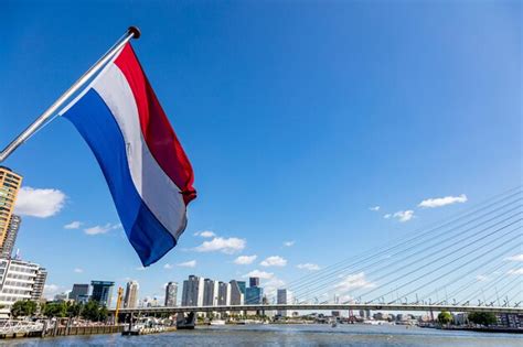 premium photo dutch national flag waving on a boat in rotterdam