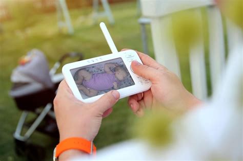 Premium Photo Man Is Checking The Baby Monitor For Security Of The Baby