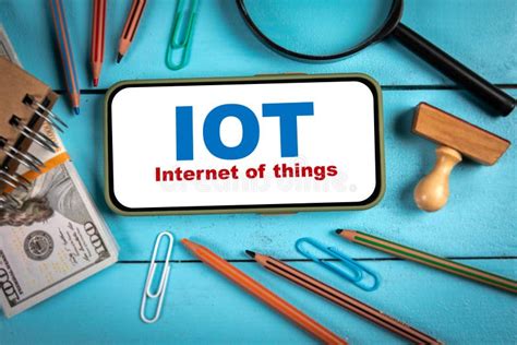 iot internet of things concept mobile phone on blue wooden table stock