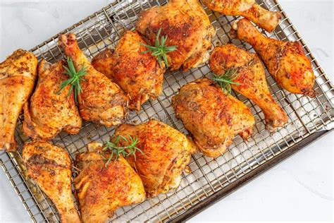 Roast Chicken Pieces On A White Plate Garnished With Fresh Rosemary